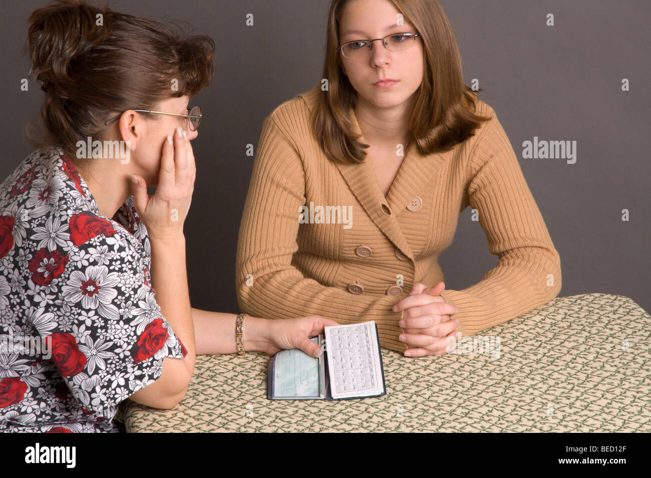 Teenage girl and her mom discussing money matters Stock Photo - Alamy