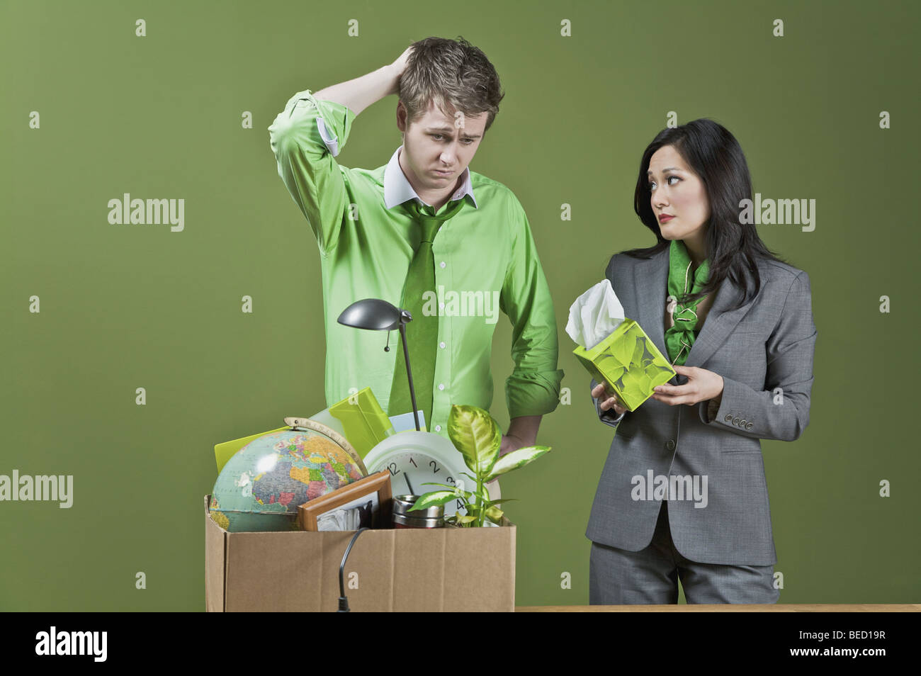 Businesswoman offering tissue papers to a fired businessman Stock Photo ...