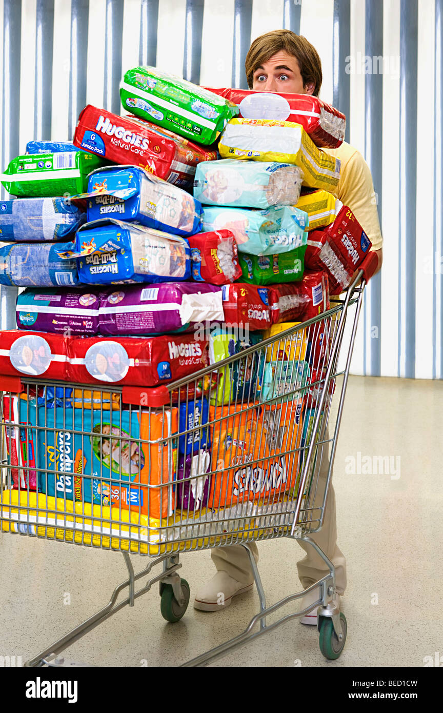 Man pushing a shopping cart Stock Photo - Alamy