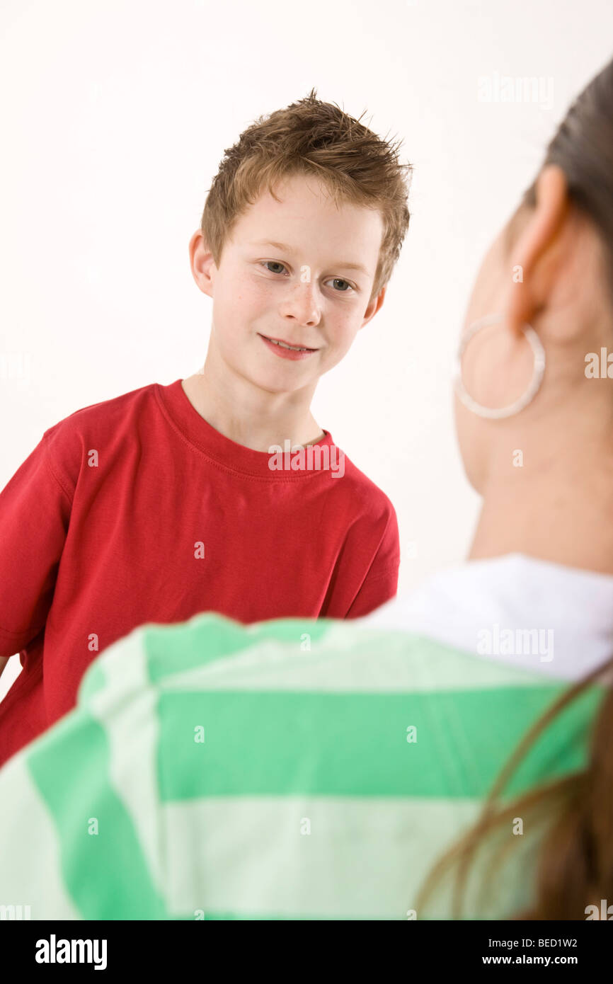 Smiling boy standing in front of a girl Stock Photo - Alamy