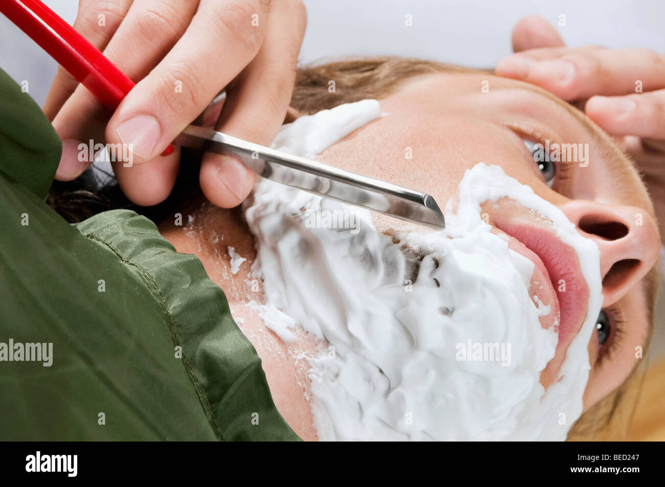 Man getting shaved in a salon Stock Photo - Alamy