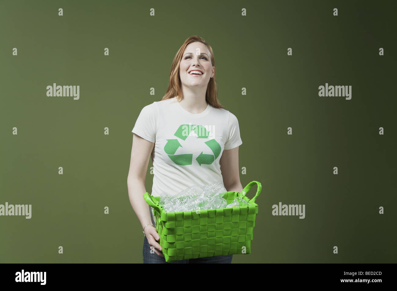 Woman holding a recycling bin and smiling Stock Photo - Alamy