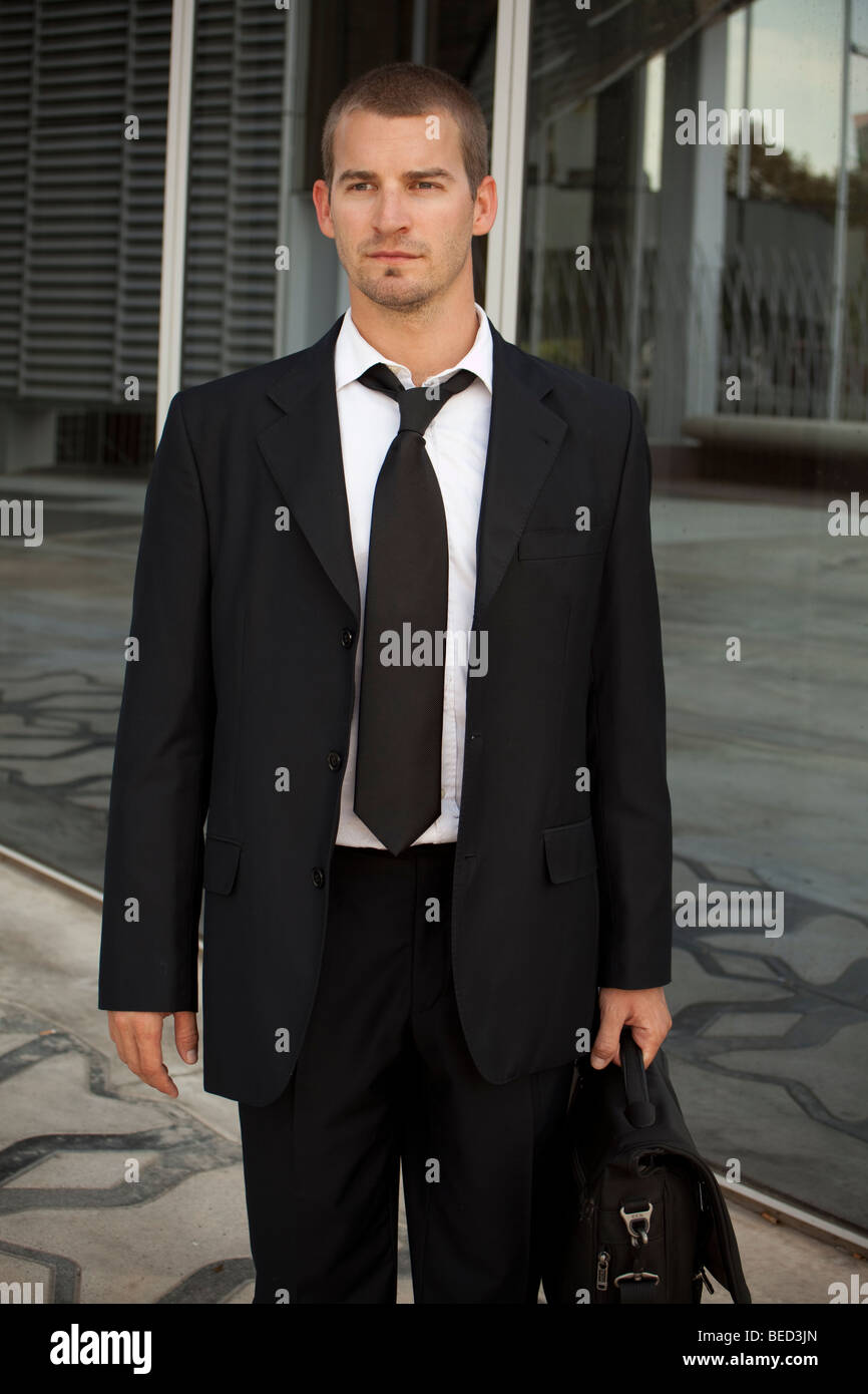 businessman standing in front of office Stock Photo - Alamy
