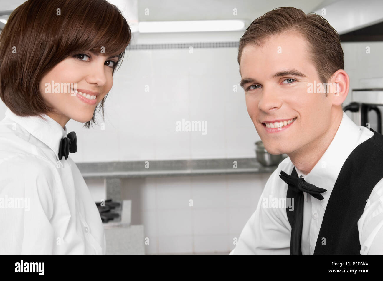 Portrait of a male and a female waiters smiling Stock Photo - Alamy