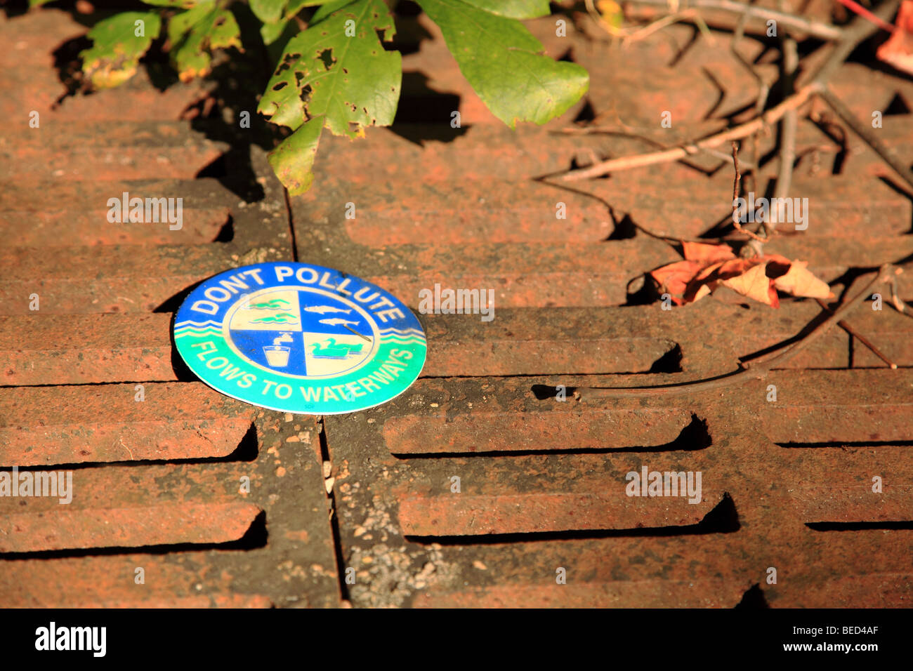 A sign on a storm drain warning about pollution of waterways Stock ...