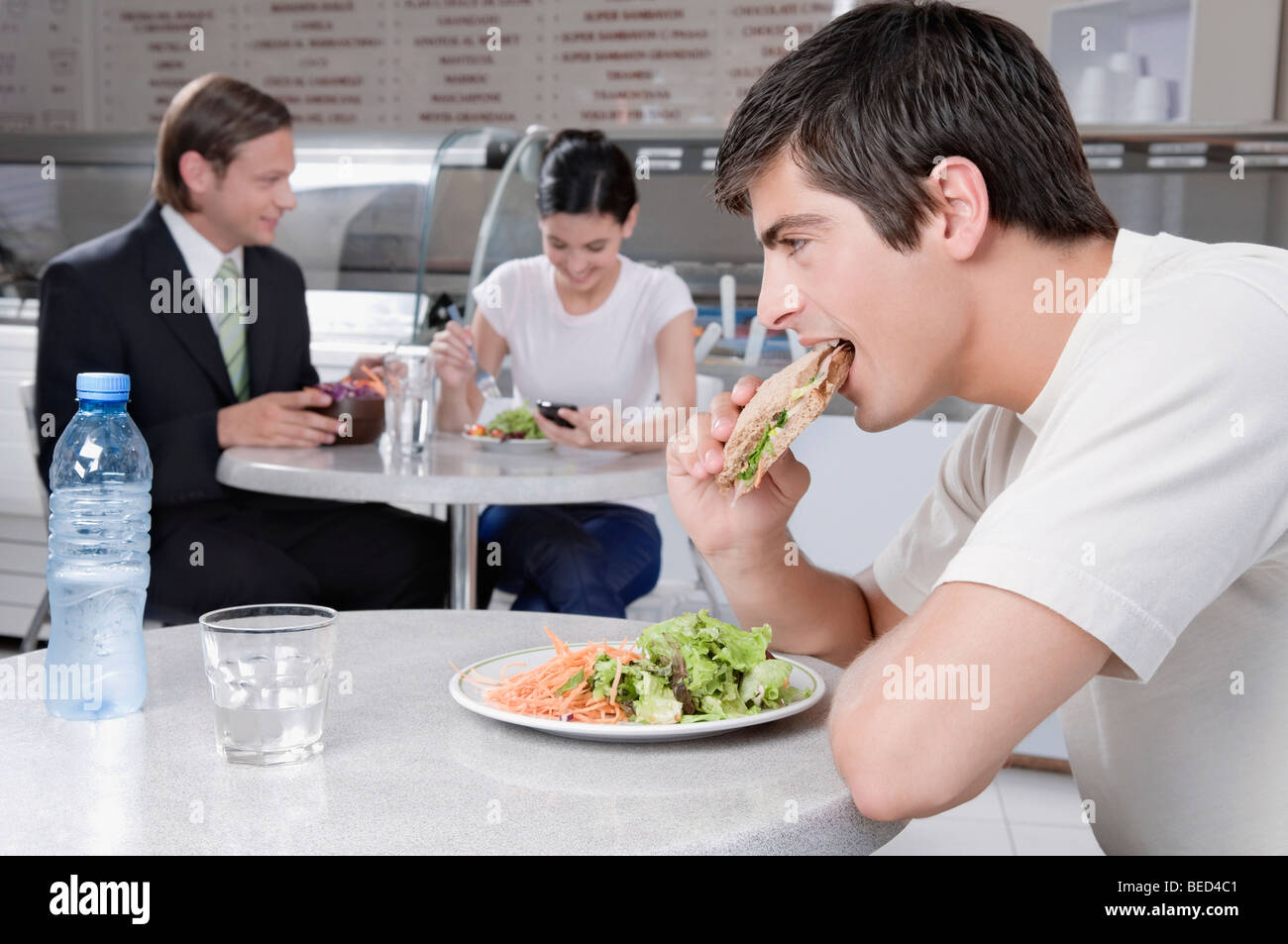 Man eating a sandwich in a restaurant Stock Photo - Alamy