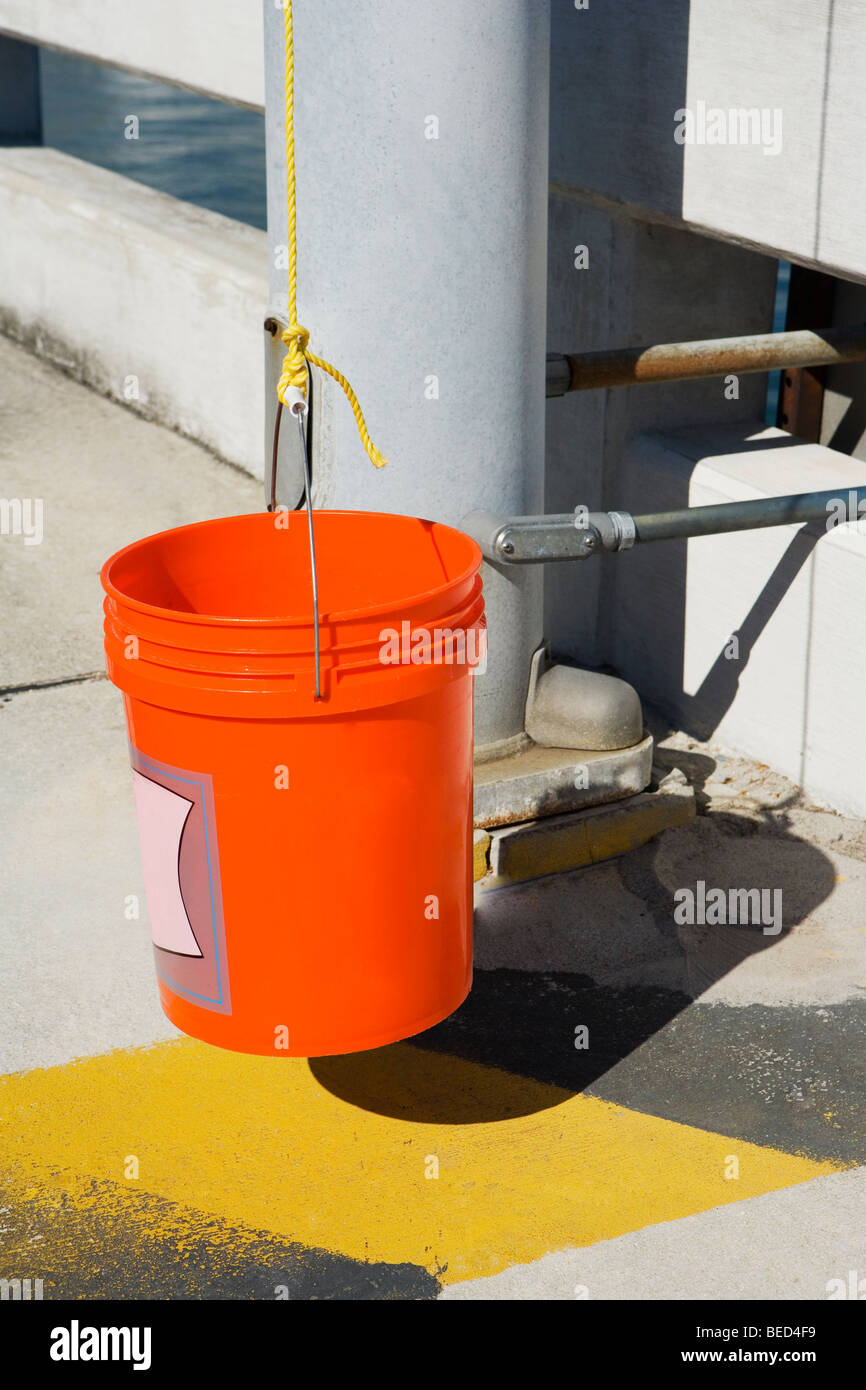 Close-up of a plastic bucket hanging from a rope Stock Photo - Alamy