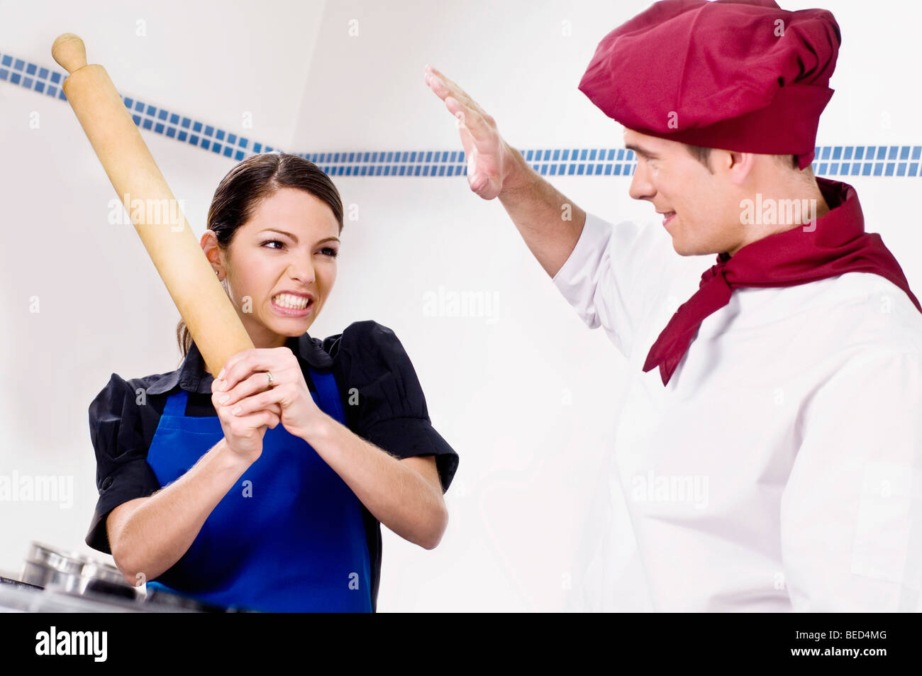 Female and a male chef fighting in the kitchen Stock Photo - Alamy