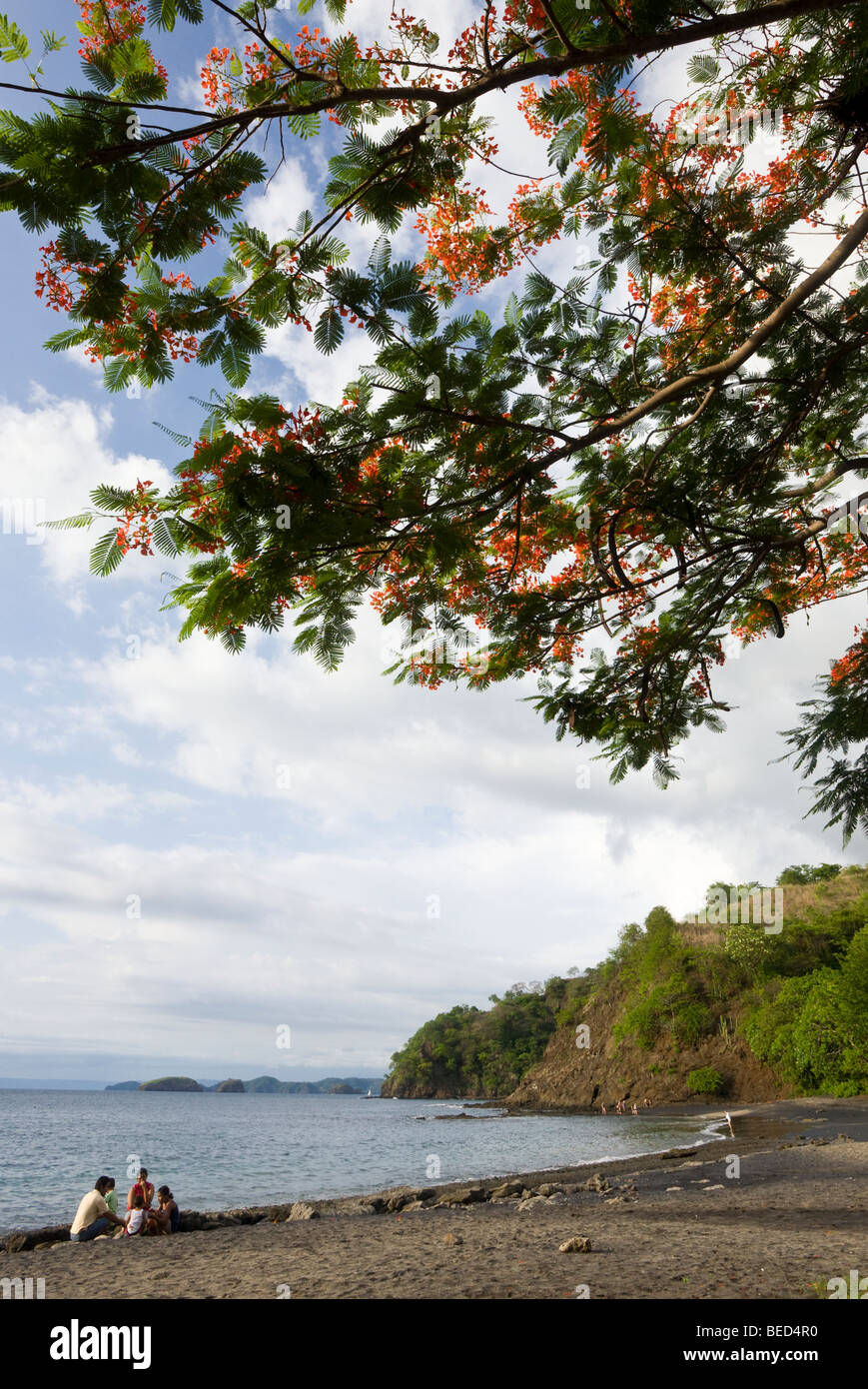 Costa Rican family picnicking along the quiet black sand beach of Playa ...