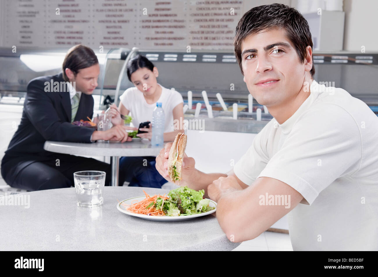 Man eating a sandwich in a restaurant Stock Photo - Alamy