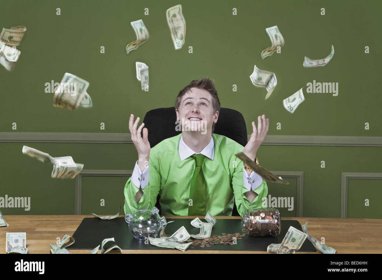 Currency notes falling over a businessman Stock Photo - Alamy