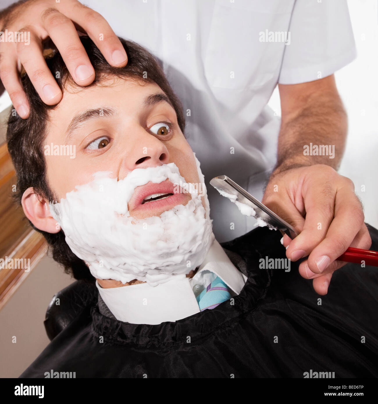 Man getting shaved in a salon Stock Photo - Alamy