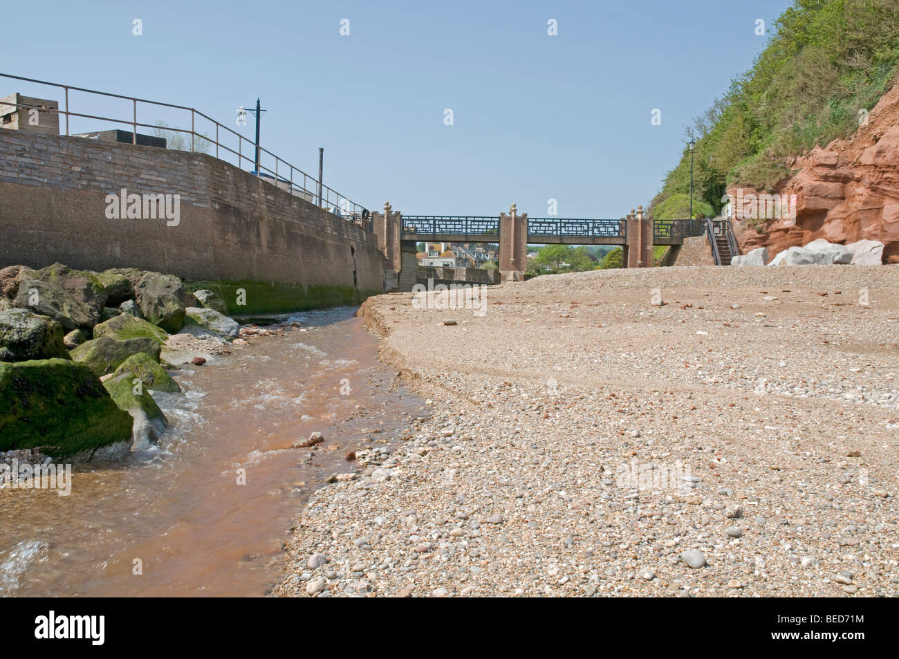 The River Sid flows seaward across the pebbly beah at Sidmouth on the ...