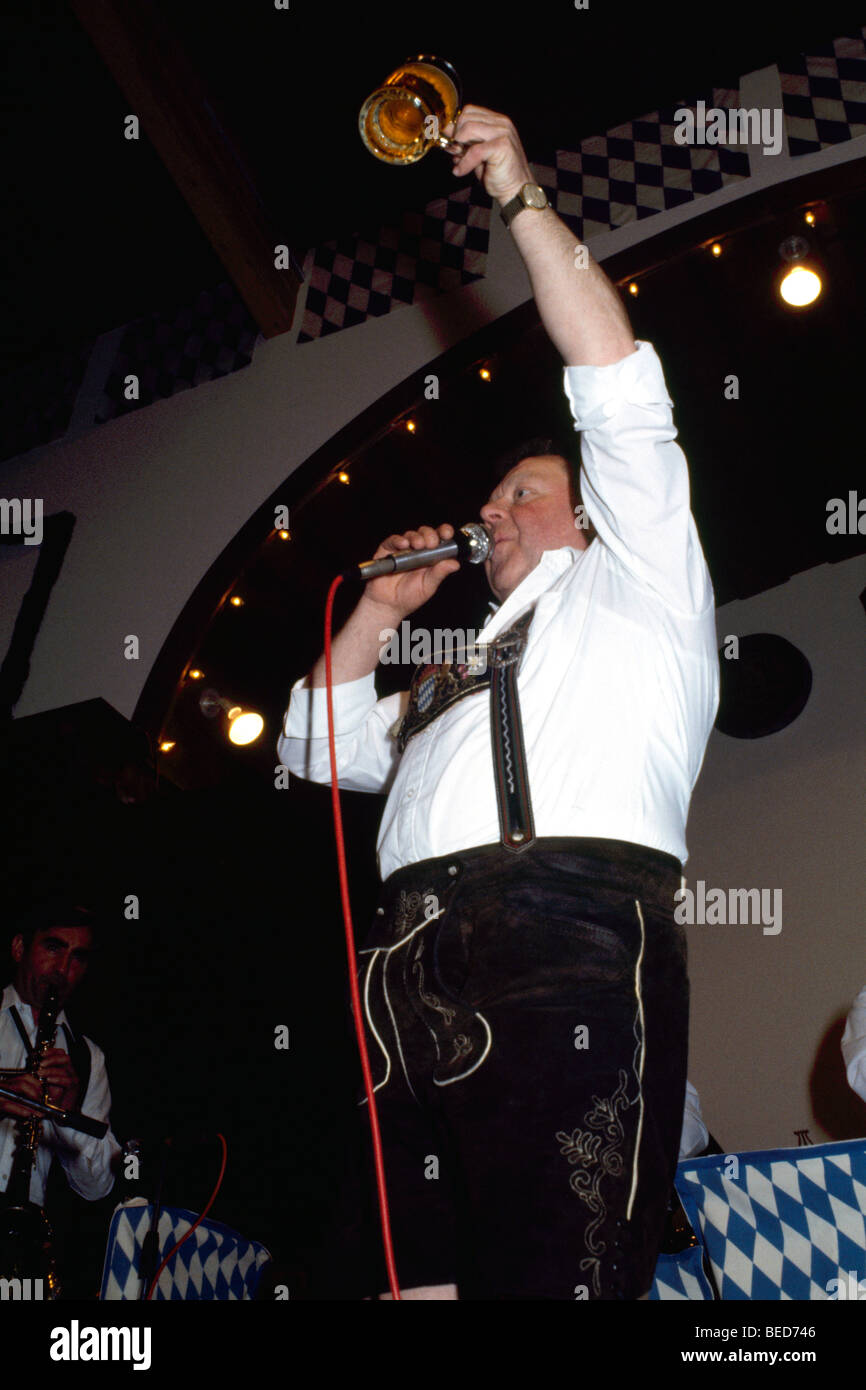Man in Traditional Bavarian Lederhosen Costume toasting Prost or Prosit ...