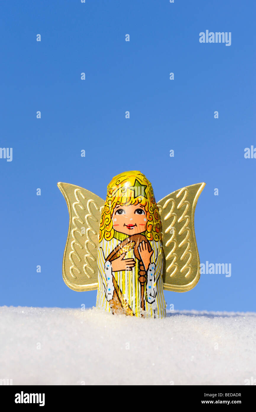 Angel in snow against blue sky Stock Photo - Alamy