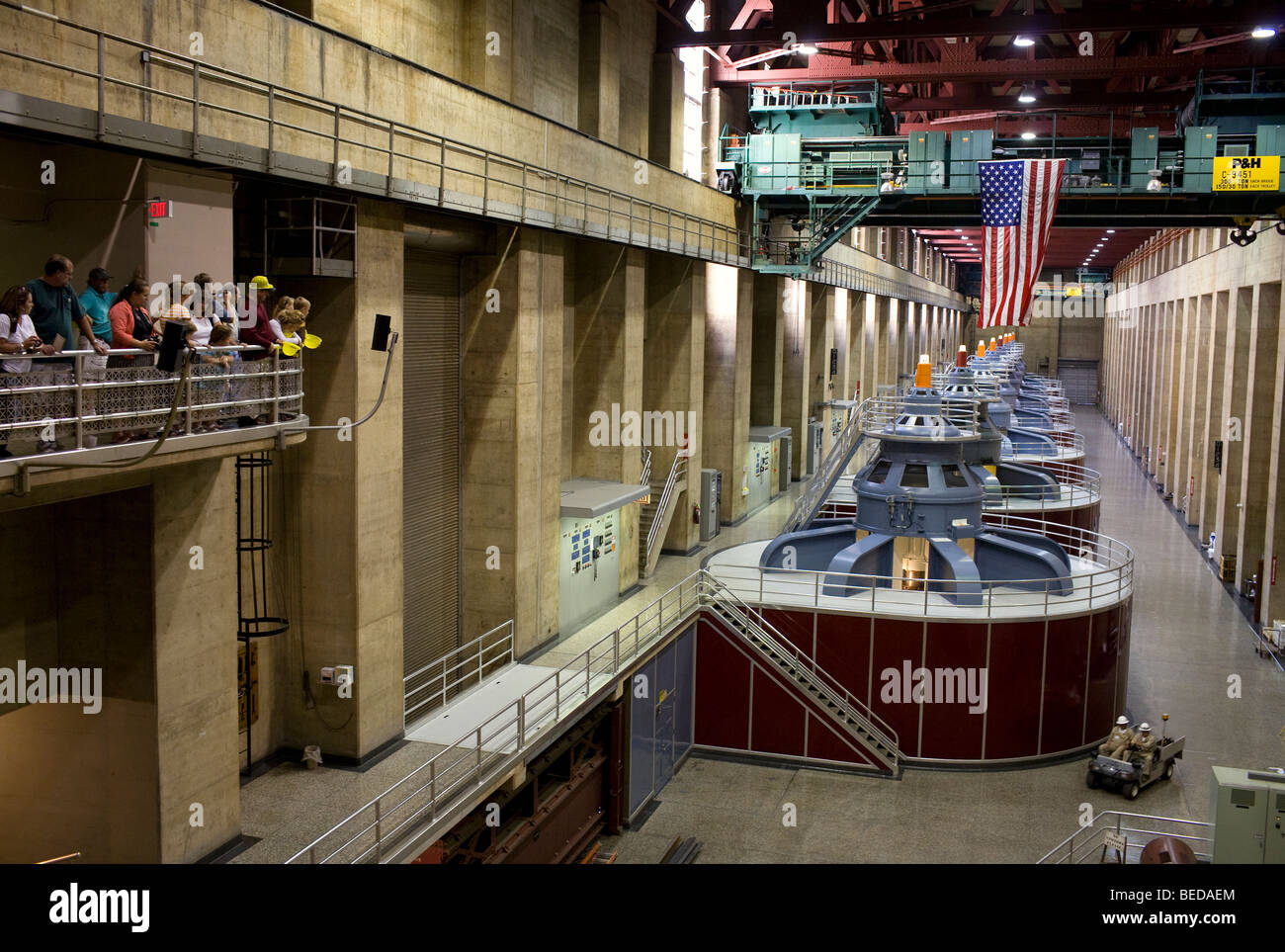 Visitors view Hoover Dam's upper generator room while taking a guided ...