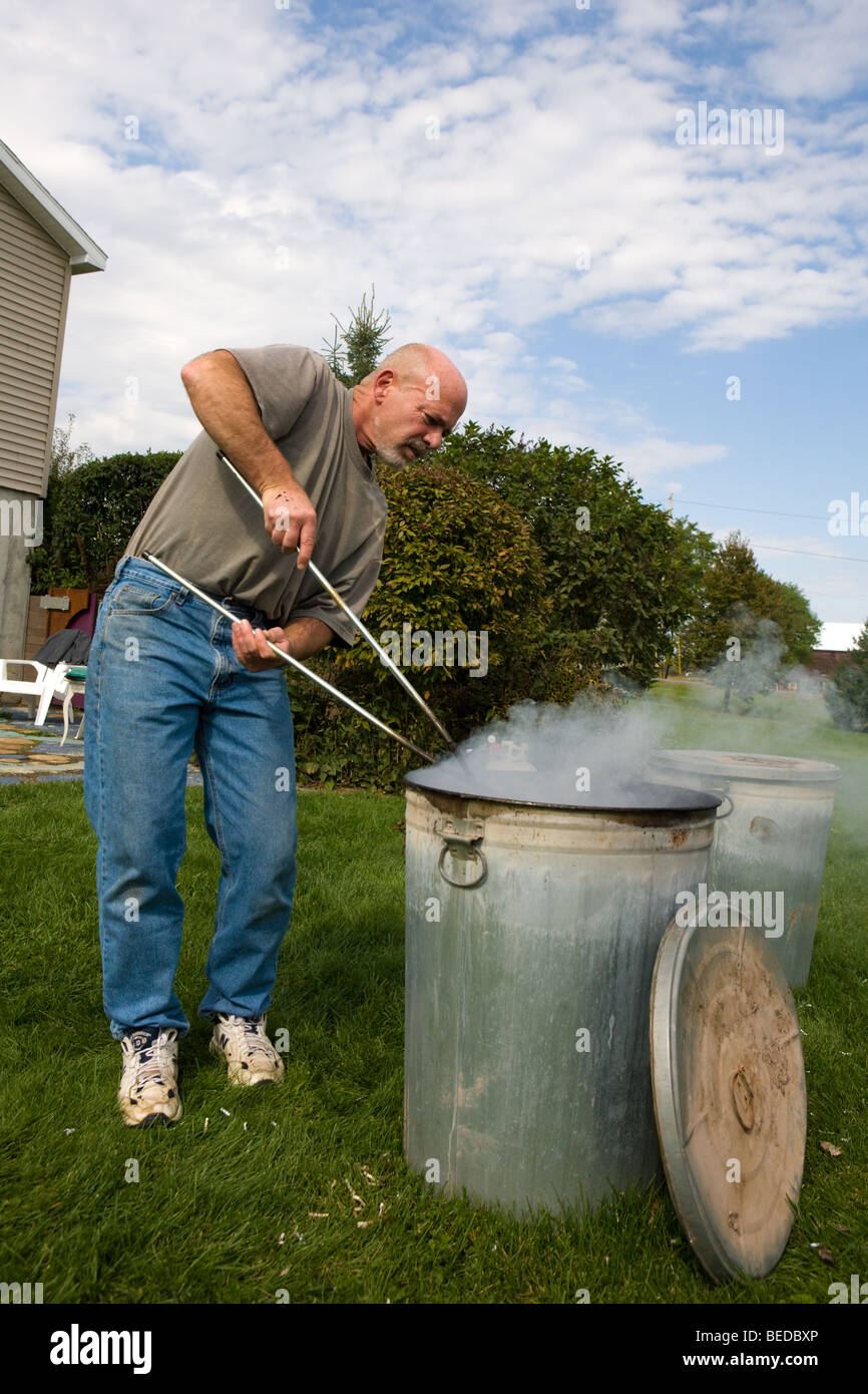 Removing pots from oxidation barrels during Raku process, USA Stock ...