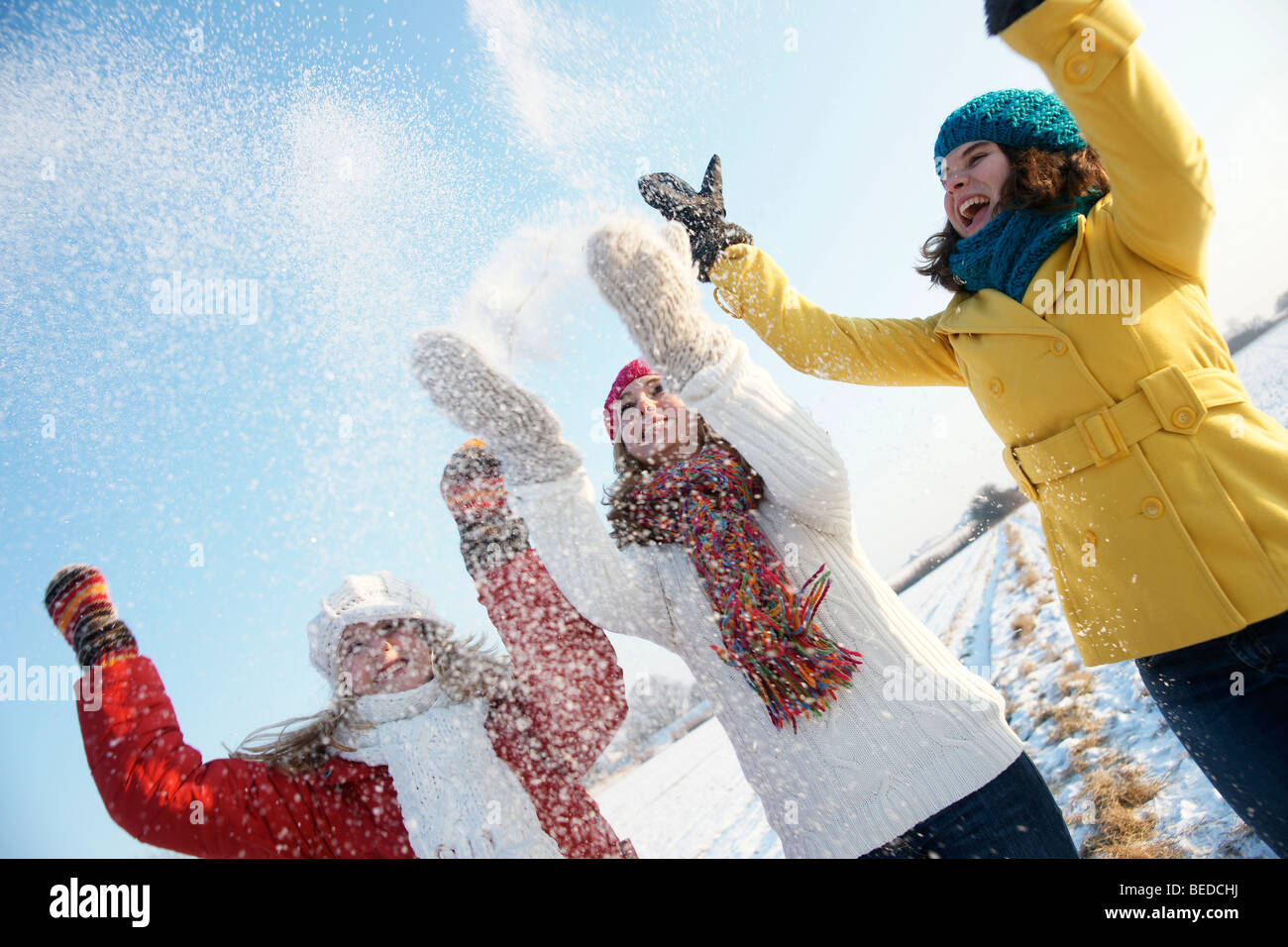 Teenage girls throwing snow on each other Stock Photo - Alamy