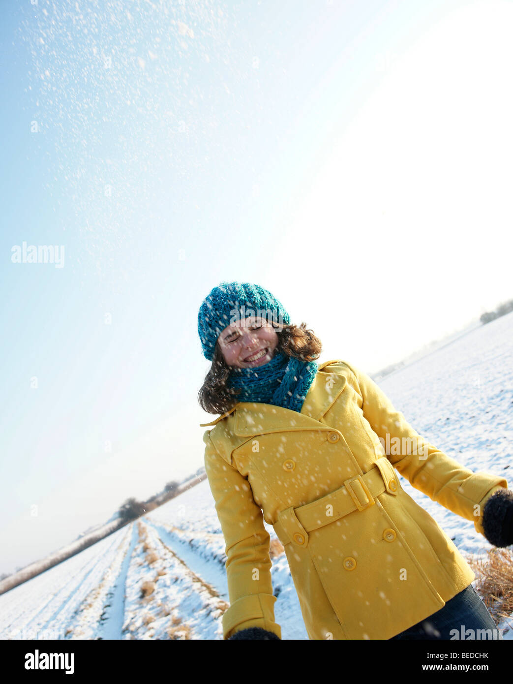 Teenage girl throwing snow up into the air Stock Photo - Alamy