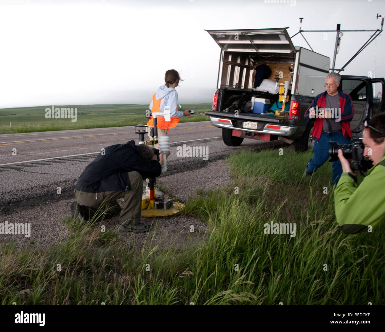 Storm chasers deploy a probe in front of a rapidly advancing tornado in ...