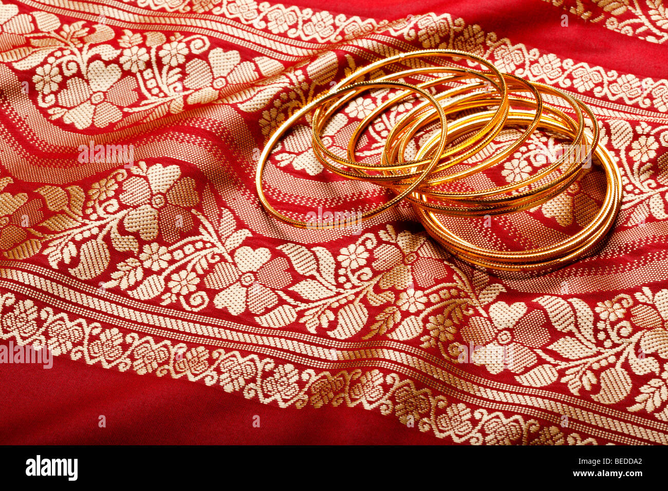 Indian sari with golden bangles close up Stock Photo - Alamy