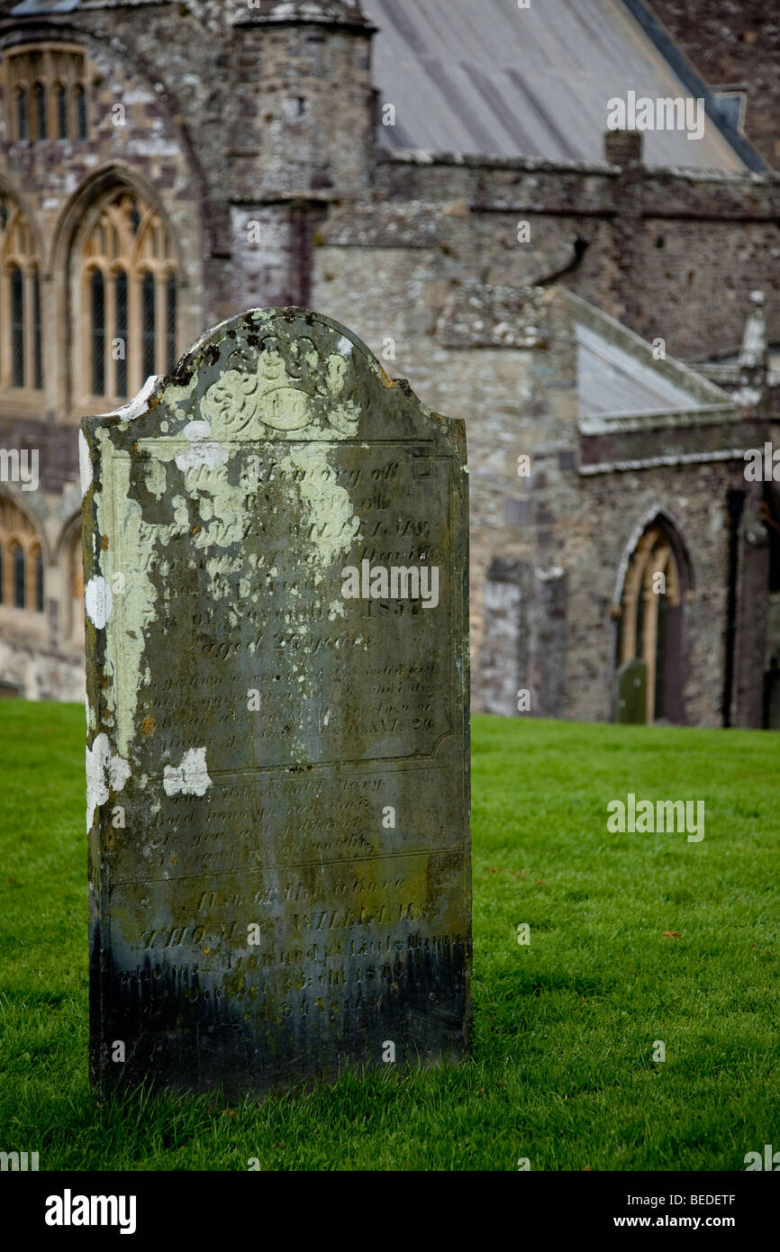 Gravestone in front of church Stock Photo - Alamy