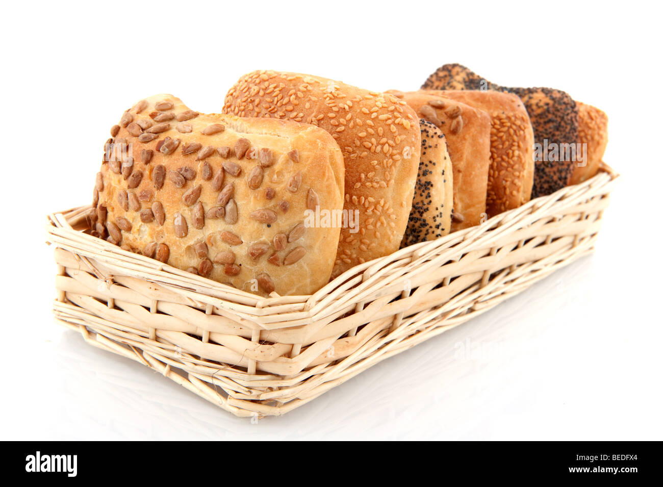 basket with luxury bread rolls with grain isolated over white Stock ...