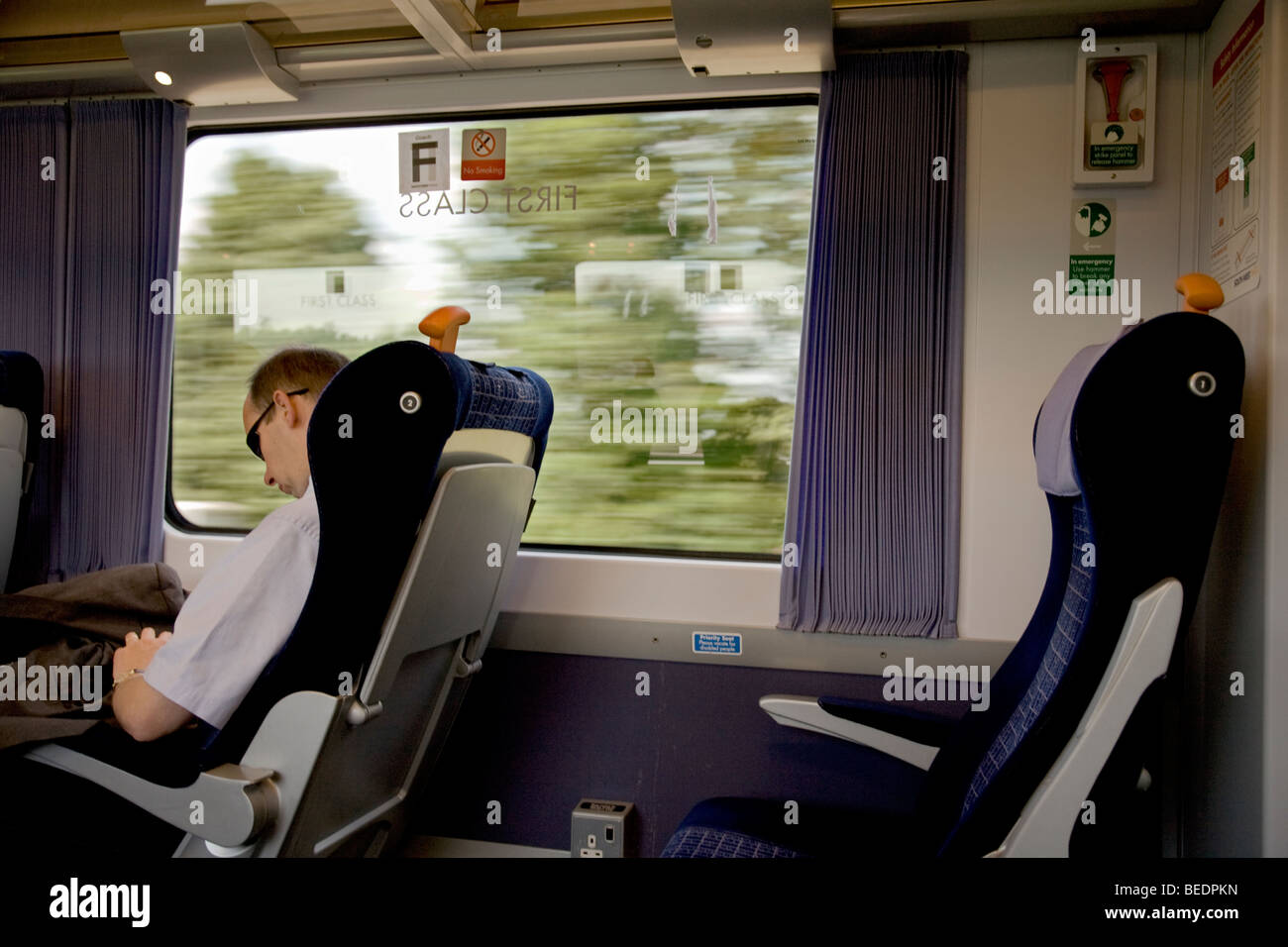 Passenger sleeping on a commuter train Stock Photo - Alamy