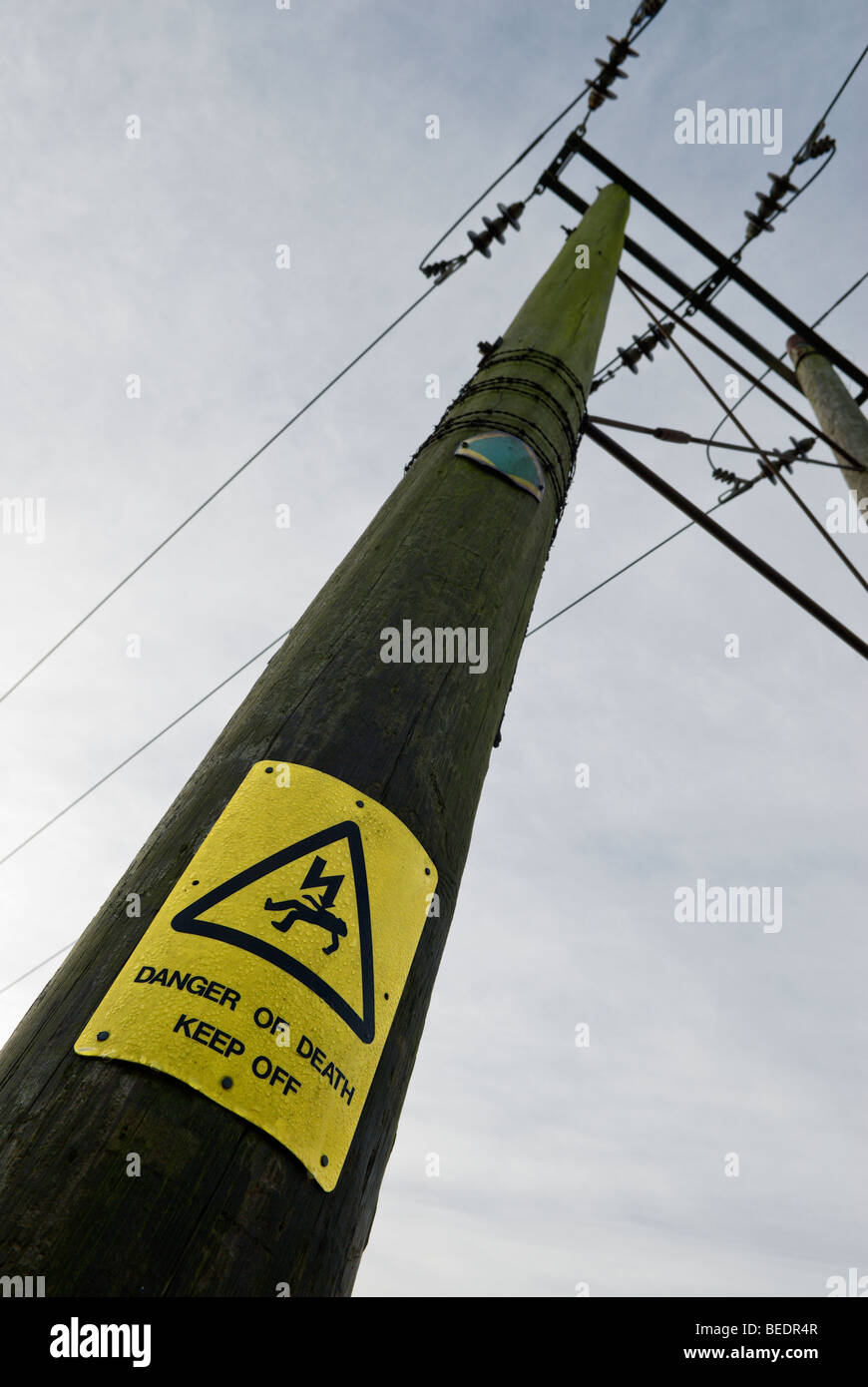 Danger signs on poles carrying electrical power lines Stock Photo - Alamy