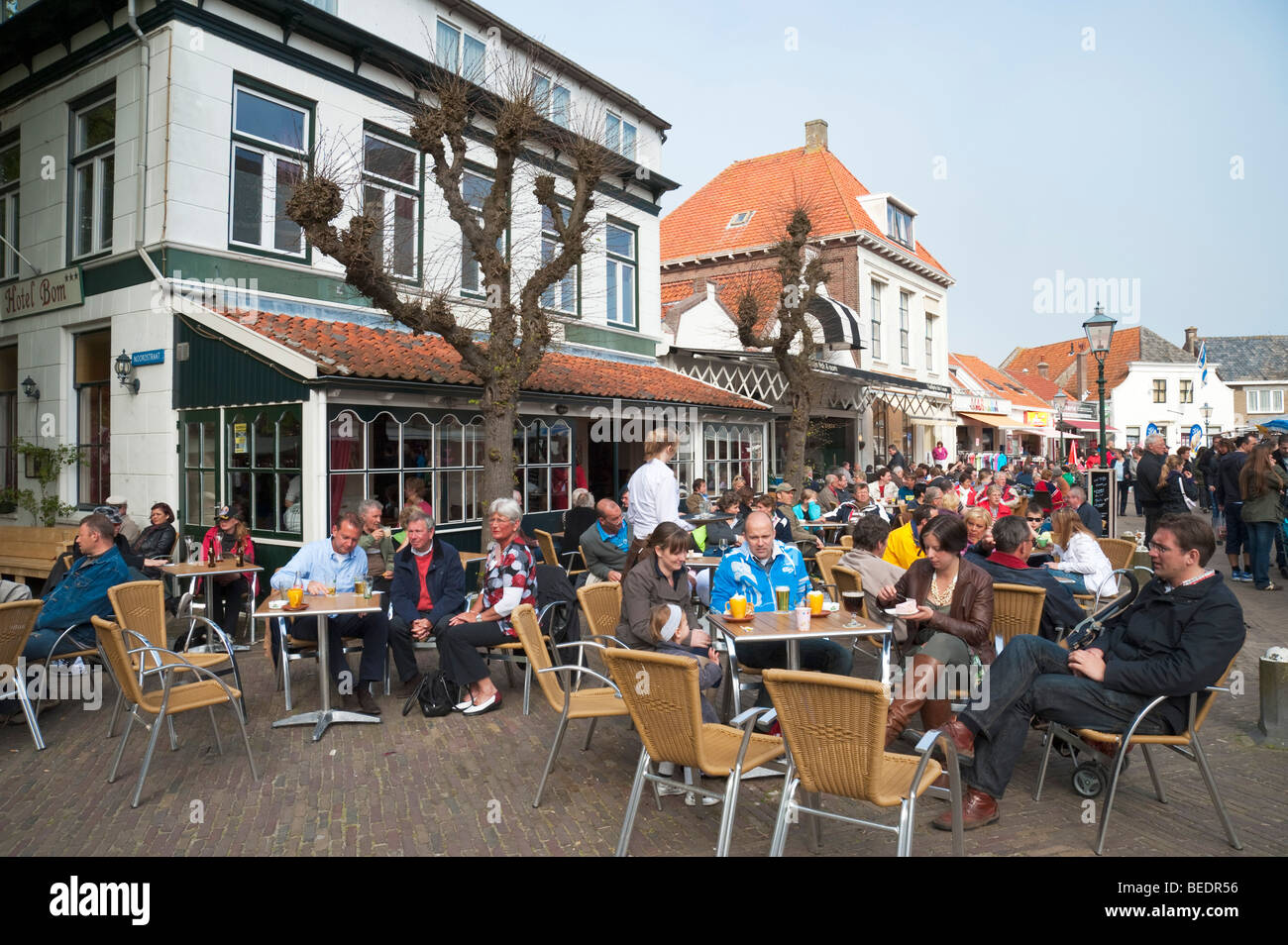 Tourists sit in a street café in the Dutch North Sea resort town of ...