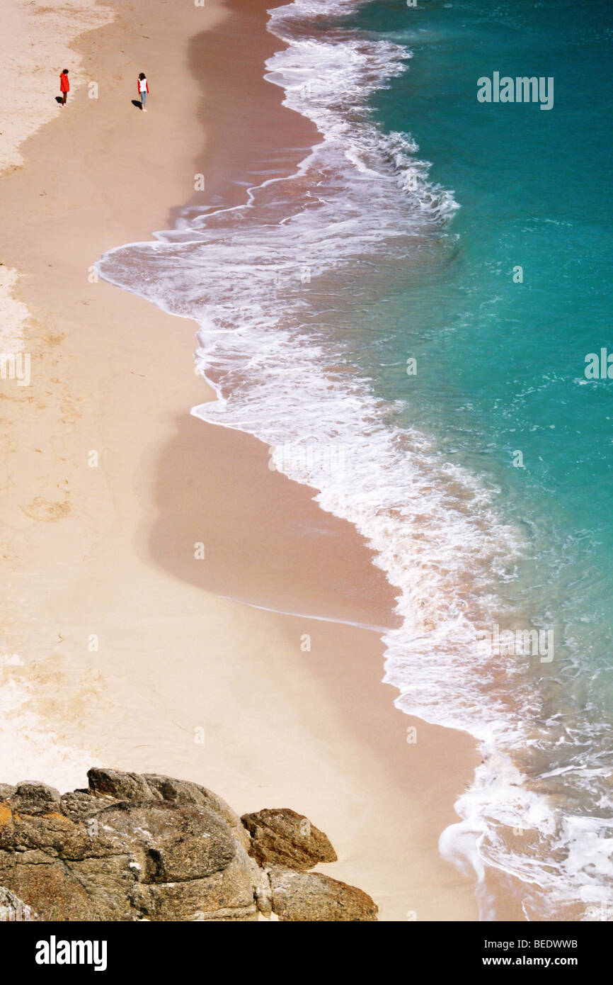 two people walking on a beautiful sandy beach Stock Photo - Alamy