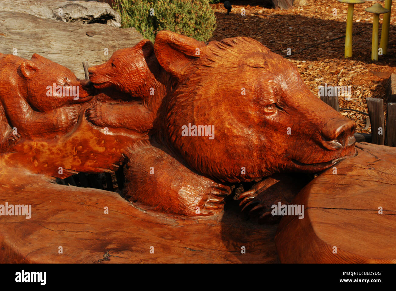 Mother bear and cubs, wood carving shown at Itsyville near Salinas ...