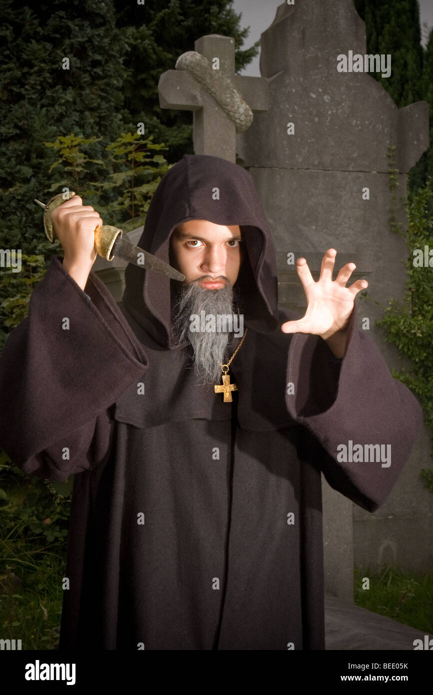 Halloween scene of an evil monk with a dagger Stock Photo - Alamy