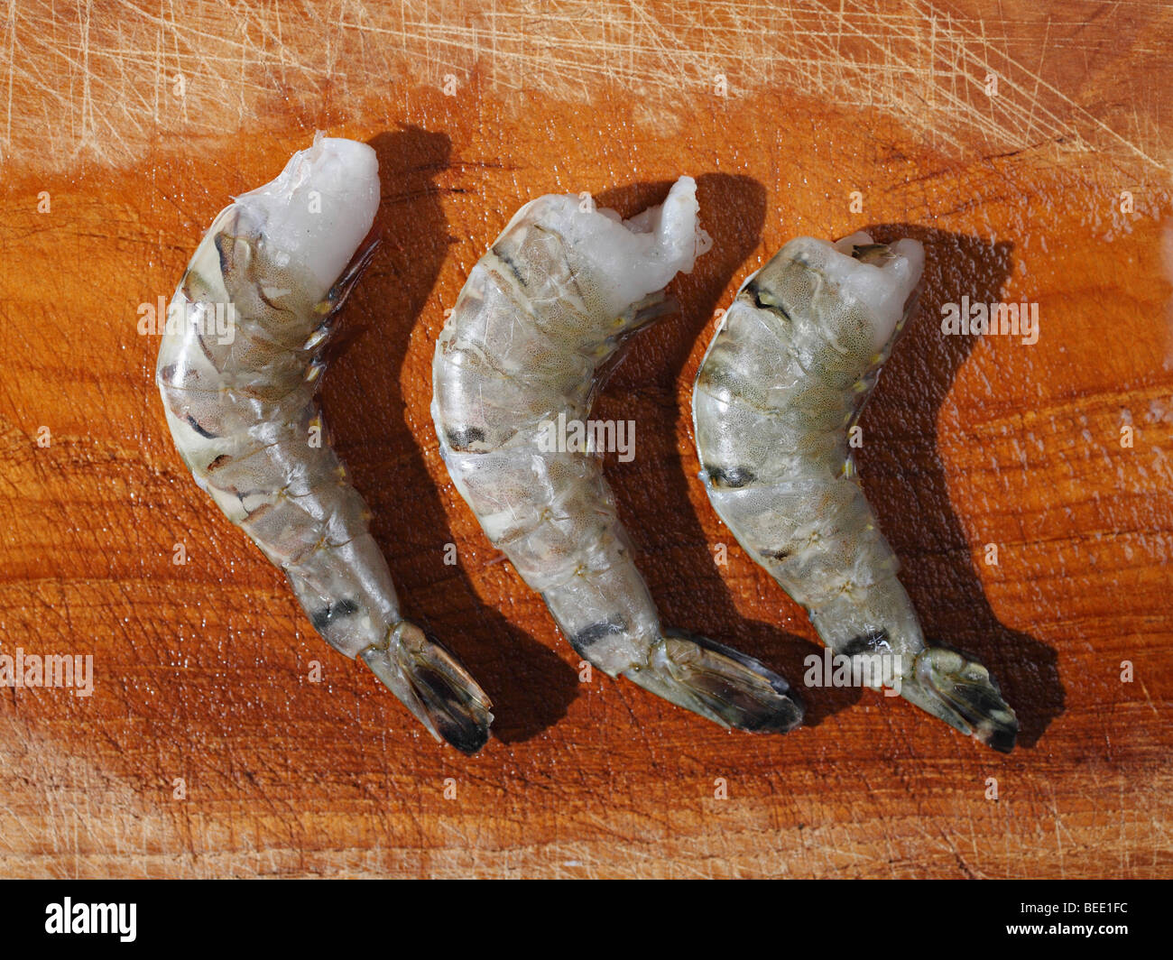 Raw prawns on wooden plate Stock Photo - Alamy