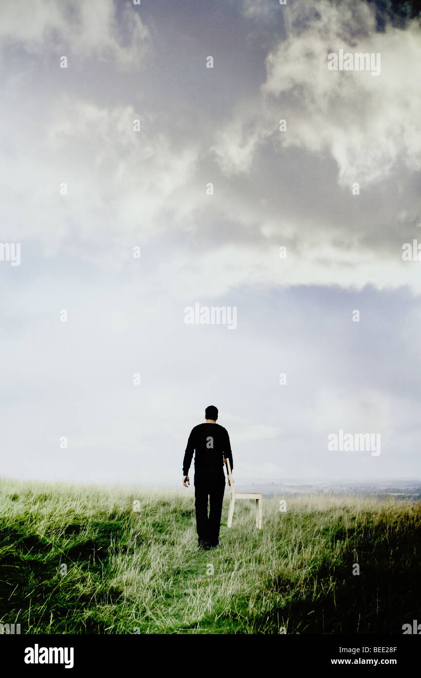 man carrying a chair Stock Photo - Alamy