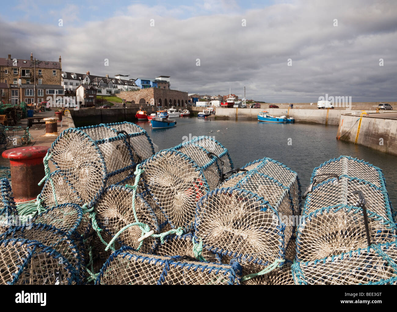 Lobster pots on the harbour wall in fishing village on the north east ...