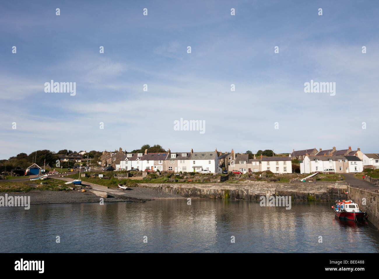 Craster, Northumberland, England, UK. View across the harbour to small ...