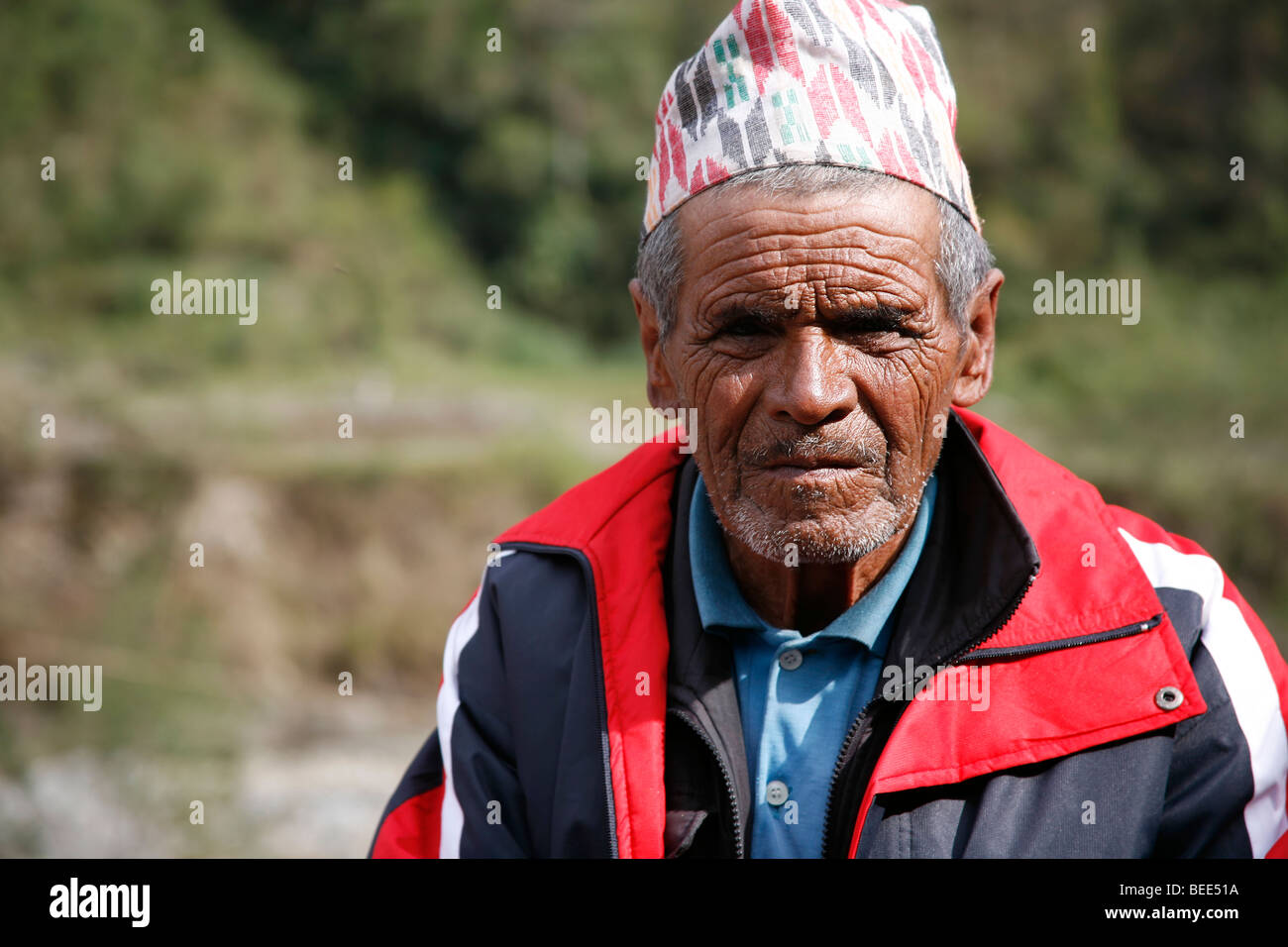 Annapurnas, Nepal - 05 April 2008. Old nepali man with traditional hat ...