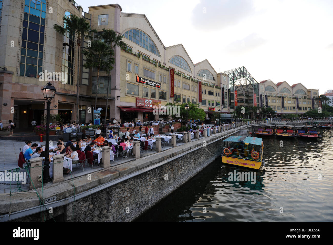 Jumbo Seafood Restaurant with people dining at outdoor riverside tables ...