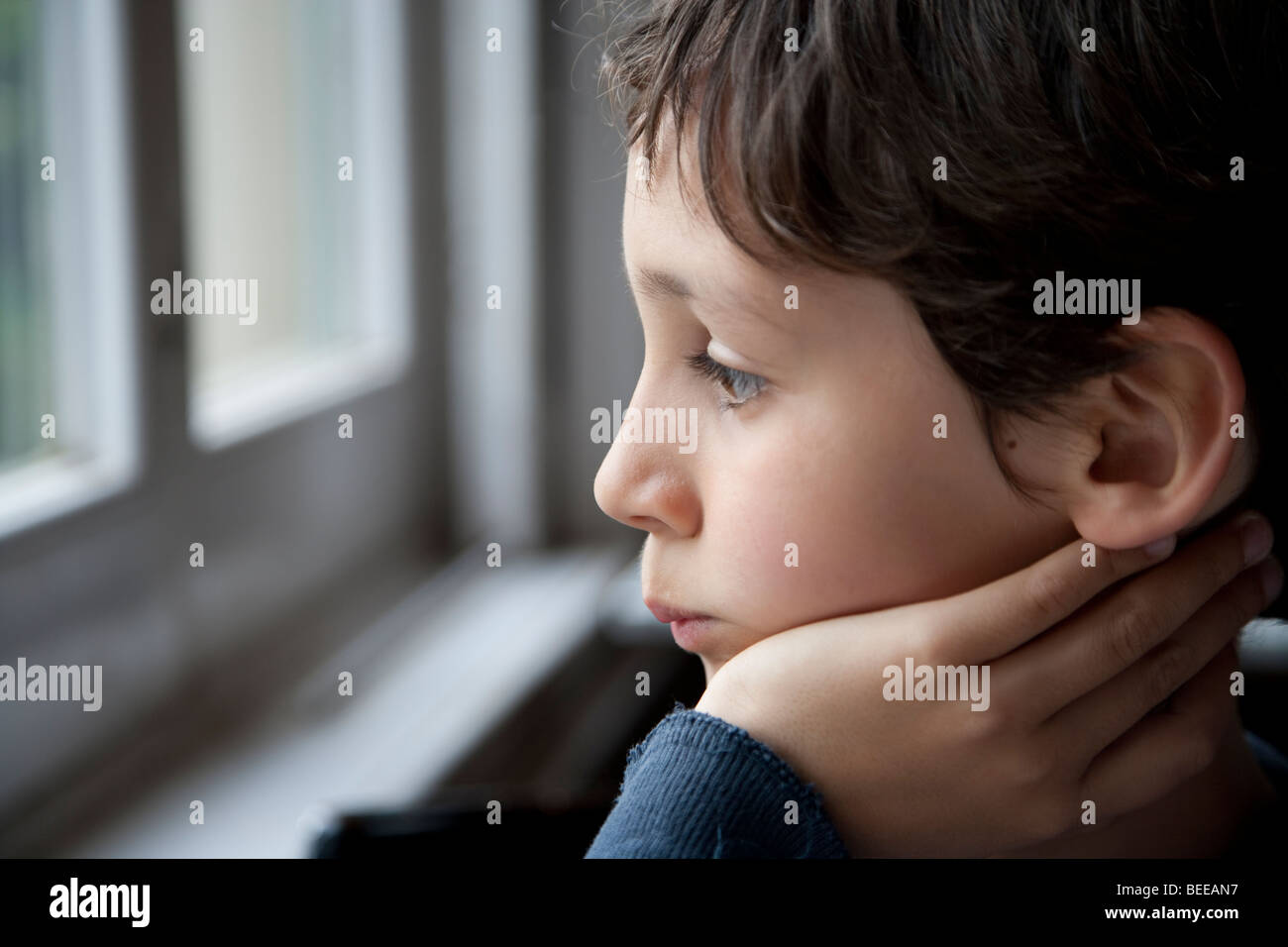 boy looking out a window Stock Photo - Alamy