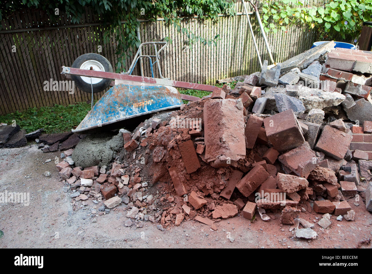 A wheelbarrow on a pile of construction concrete demolition debris ...