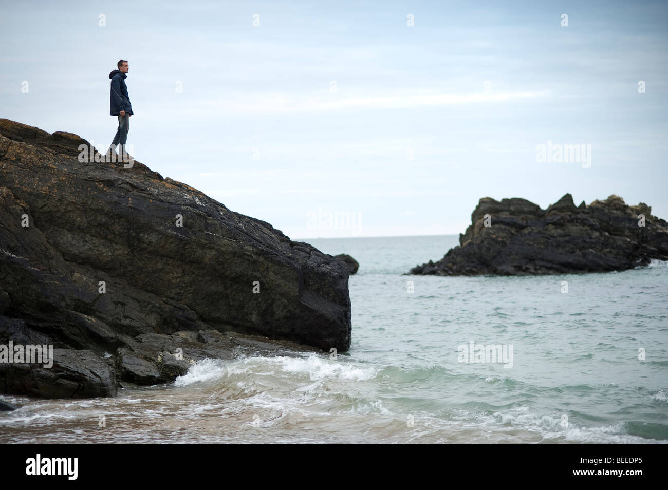 Bird watcher looking out to sea Stock Photo - Alamy