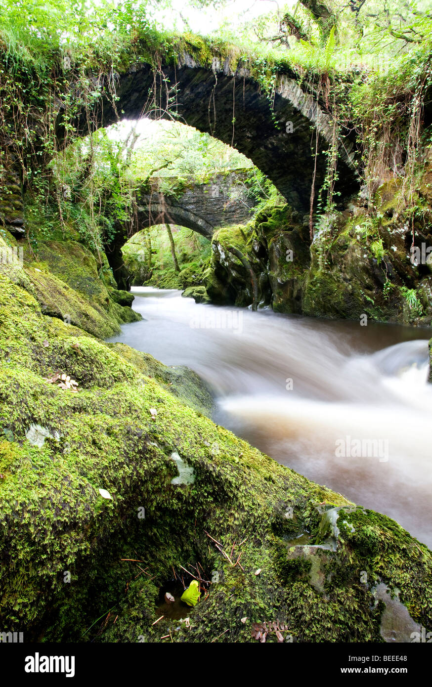 The ancient Roman bridge over the River Machno at Penmachno near Betws ...