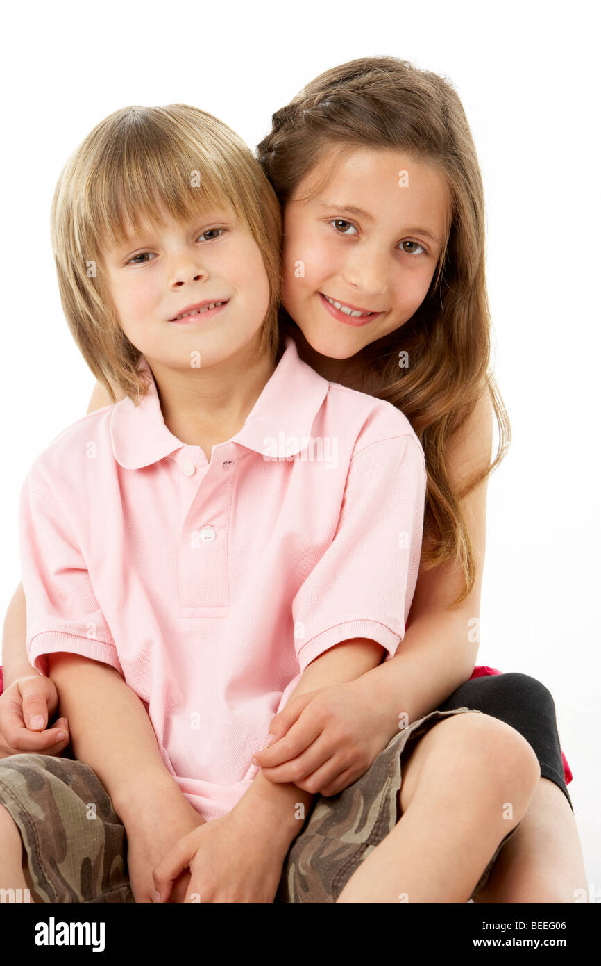 Two Children Sitting with each other in Studio Stock Photo - Alamy