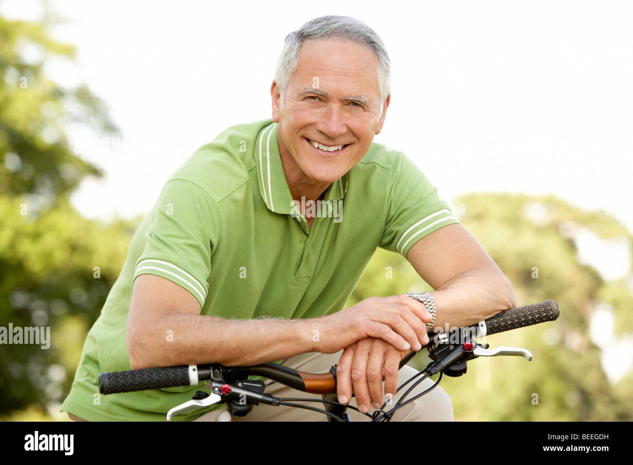 Portrait of man riding cycle in countryside Stock Photo - Alamy