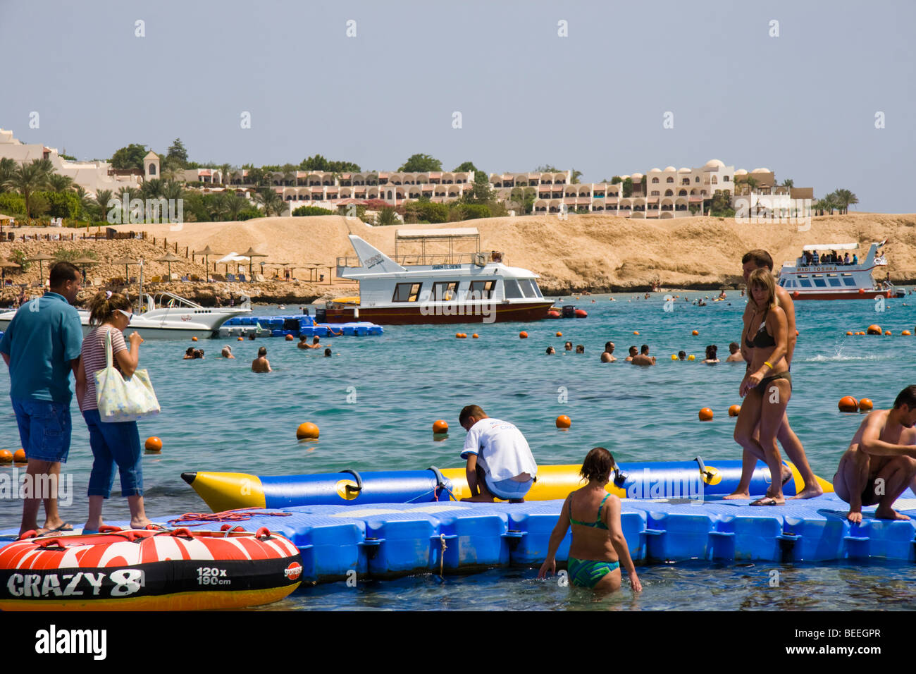 Tourists enjoying the sun at Naama Bay beach, Sharm el Sheikh, Red Sea ...