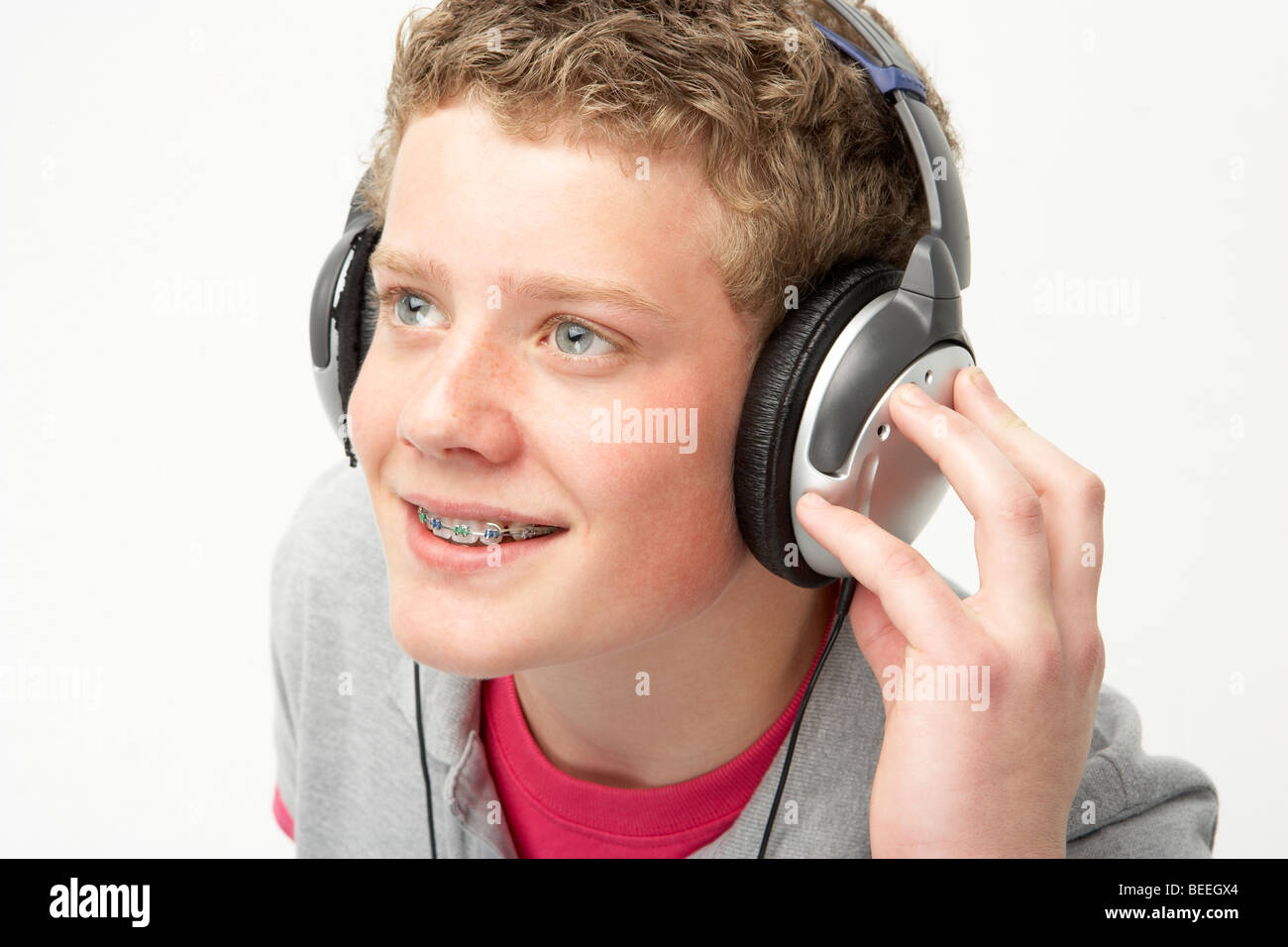 Portrait of Smiling Teenage Boy Listening to Music Stock Photo - Alamy