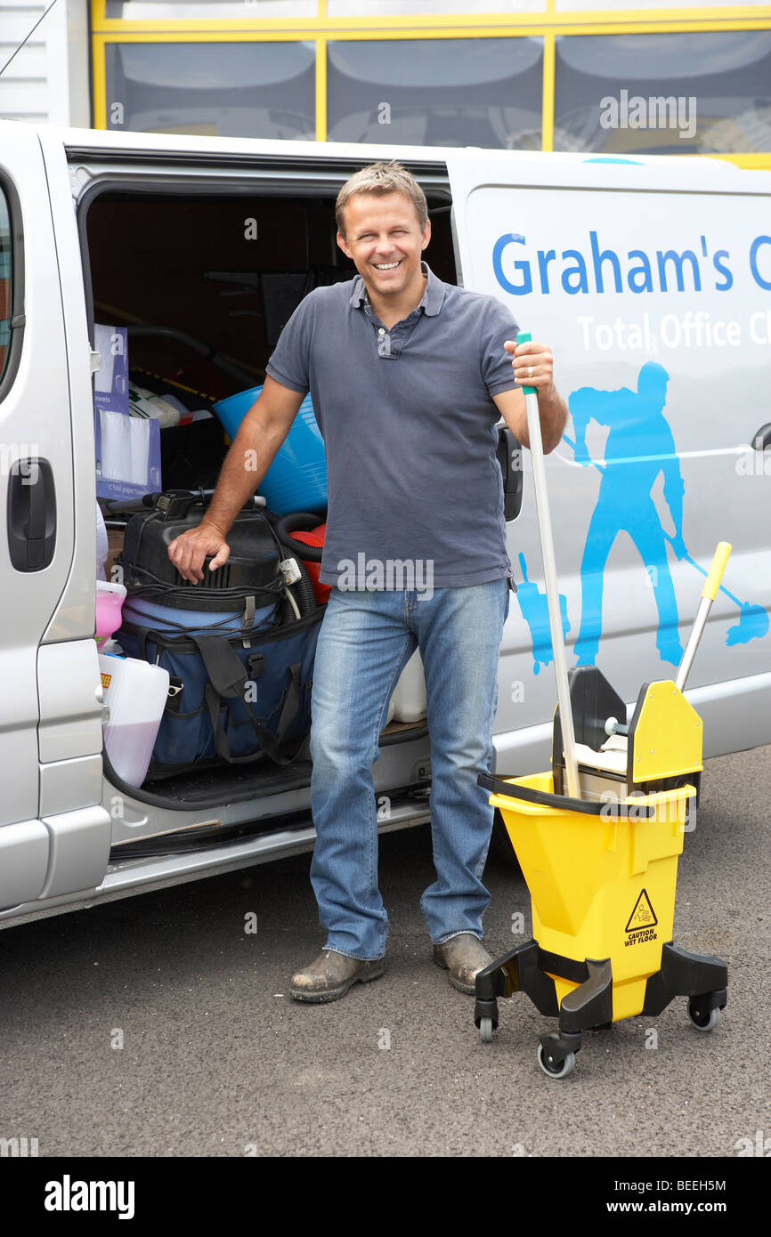 Cleaner standing next to van Stock Photo - Alamy