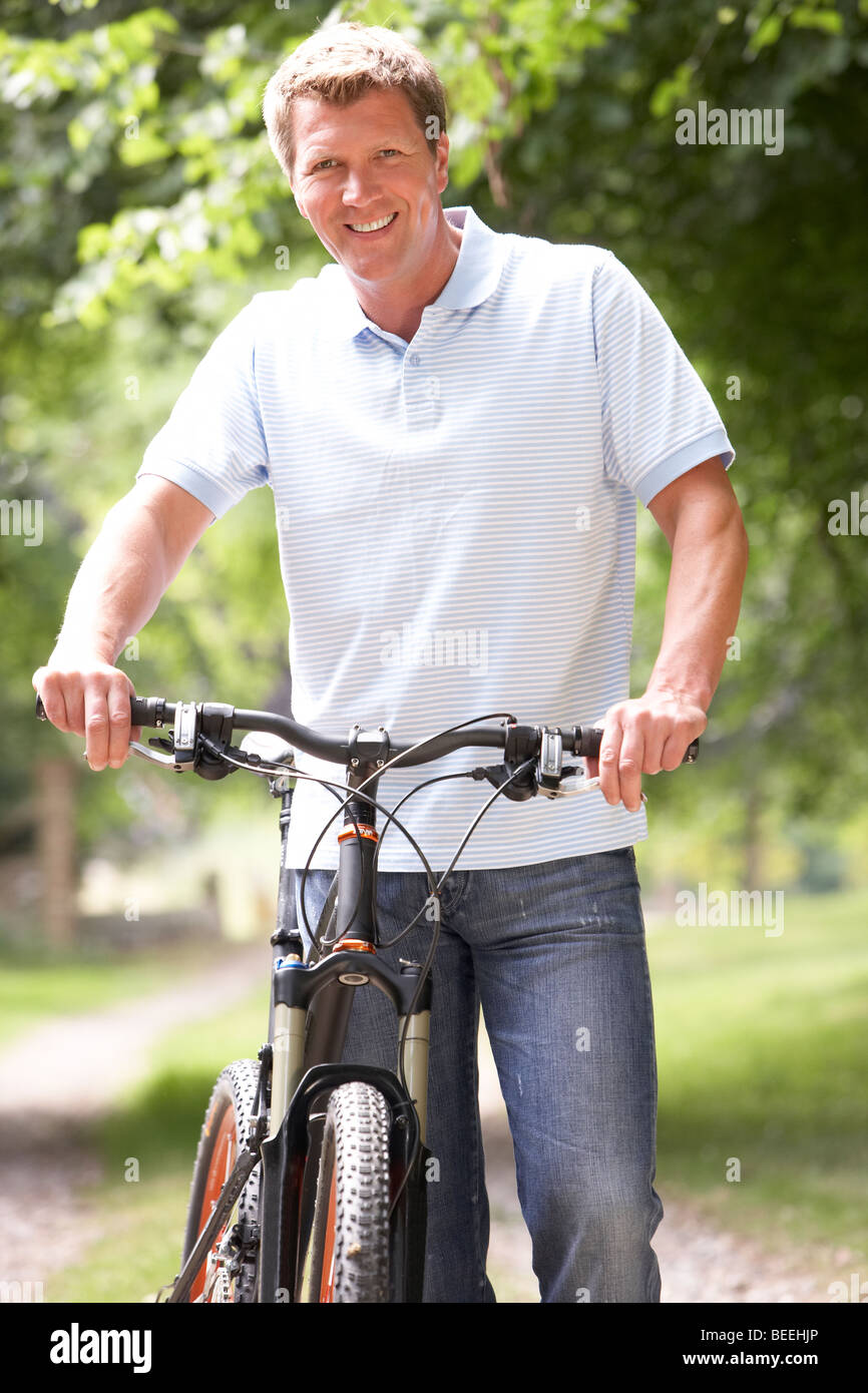 Young man riding bike in countryside Stock Photo - Alamy