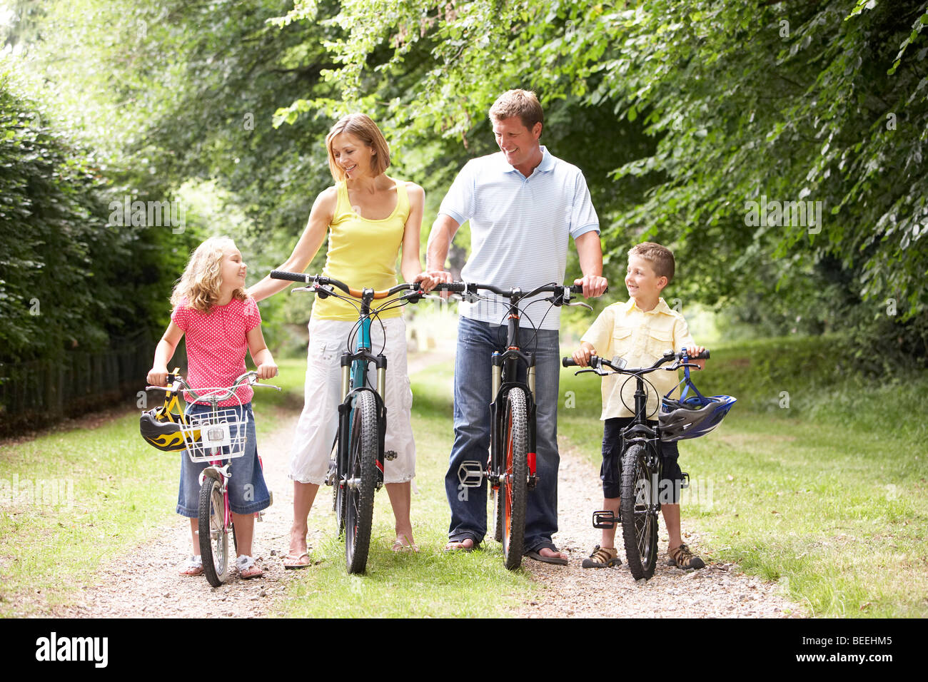 Family riding bikes in countryside Stock Photo - Alamy